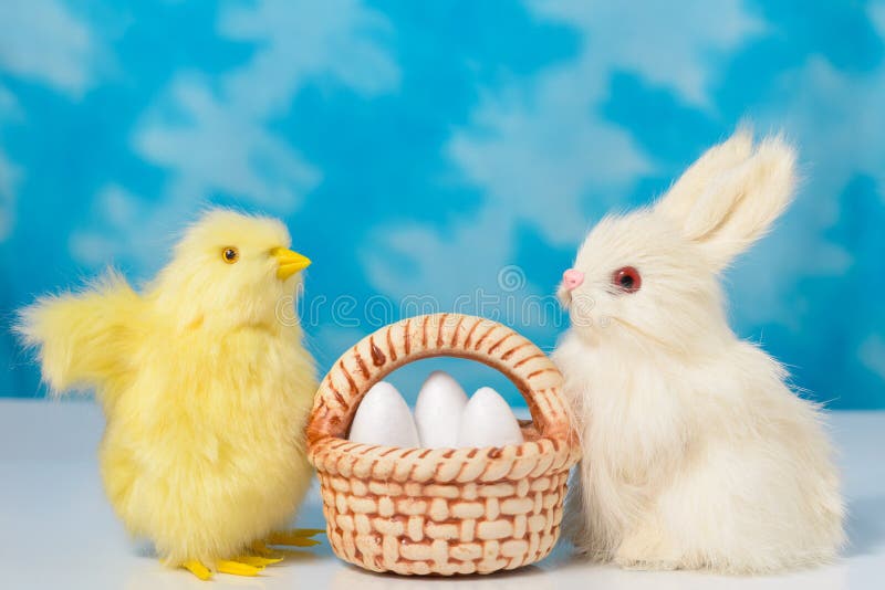 Bunny and Chick with Basket of Easter Eggs on a Background of Blue Sky ...