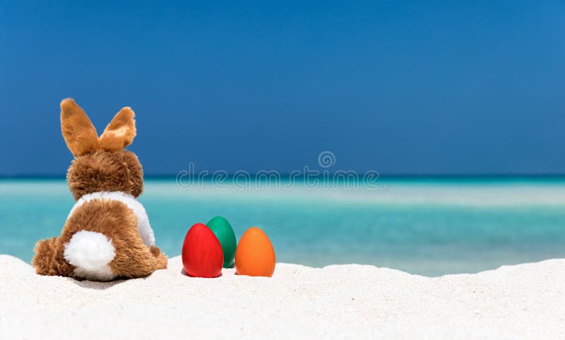 Bunny and Colored Easter Eggs on a Beach Stock Photo - Image of space ...