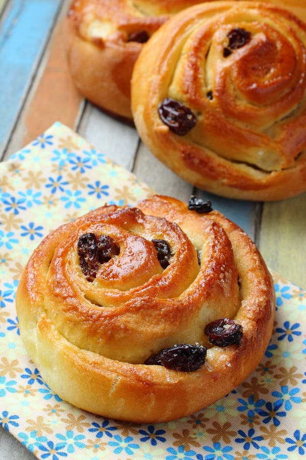 Buns with Raisins on Colored Wooden Table Stock Photo - Image of ...