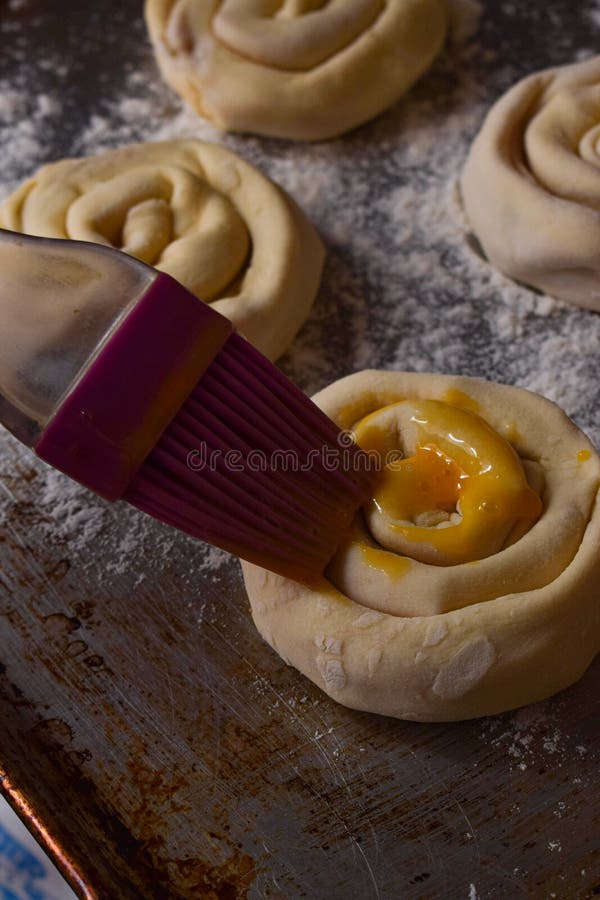 A Portion of Raw Buns is Smeared with the Yolk of an Egg with a ...