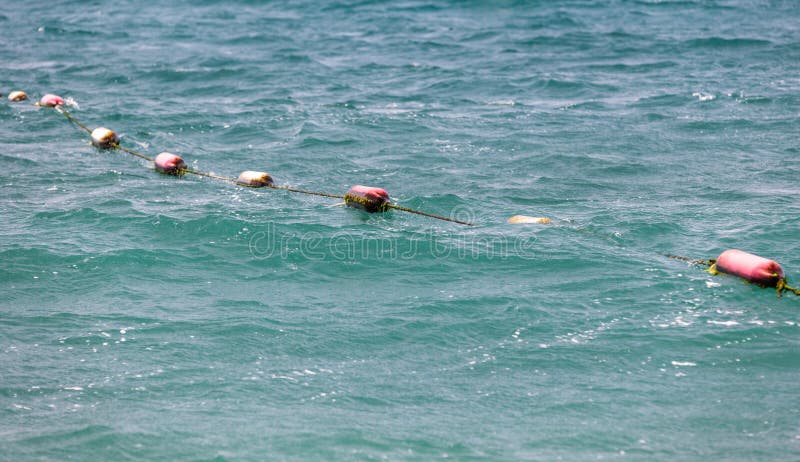 Buoys Float on a Line Dividing the Calm Ocean Surface Stock Photo ...