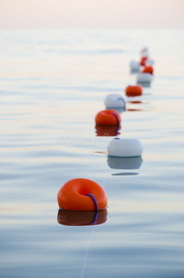 String Of Buoys Floating On Ocean Surface Stock Image - Image of coast ...