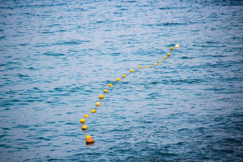 Buoys Strung Together and Floating on Water Stock Image - Image of ...