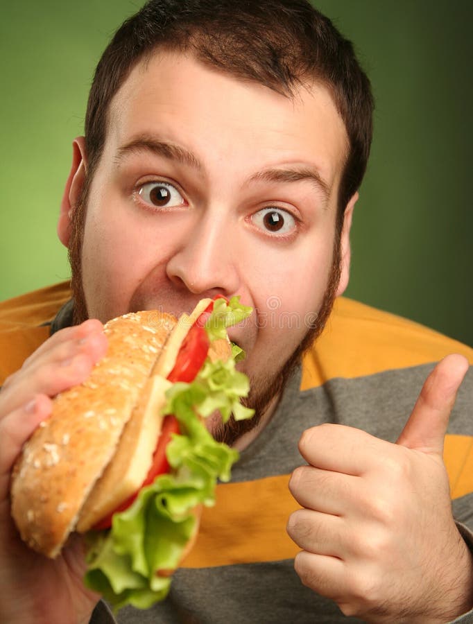 Fat man eating hamburger stock image. Image of expression - 38665669
