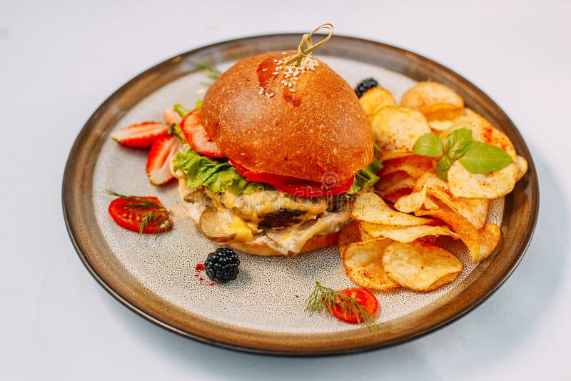 Burger with Beef Patty and Potato Chips on a White Decorated Table ...