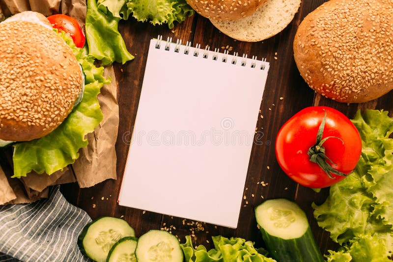 Burger with Ingredients and Notepad on Table Stock Photo - Image of ...