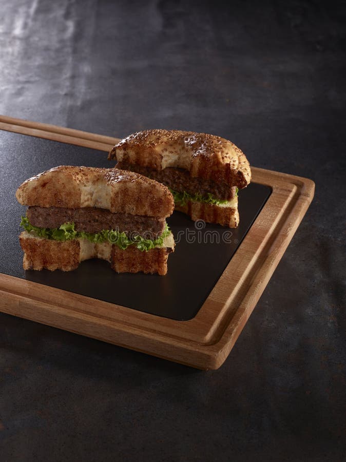 Burger with Meat and Lettuce Cut To Half on Hot Plate Stock Photo ...