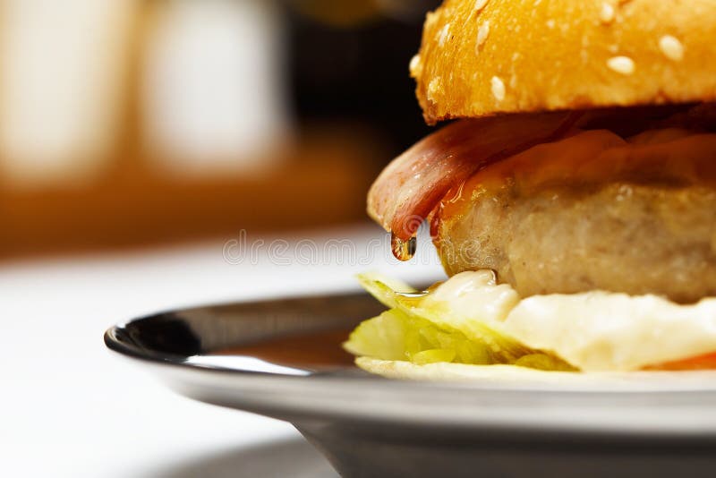 Burger on a Mirror Plate with Sauce and a Potatoes Stock Photo - Image ...