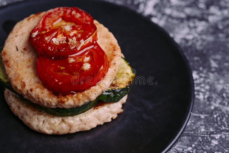 Burger Plate with Grilled Vegetables on a Black Plate Stock Photo ...