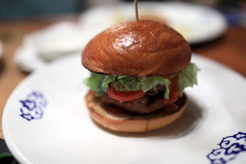 Burger on plate stock photo. Image of diner, barbecue - 142227800
