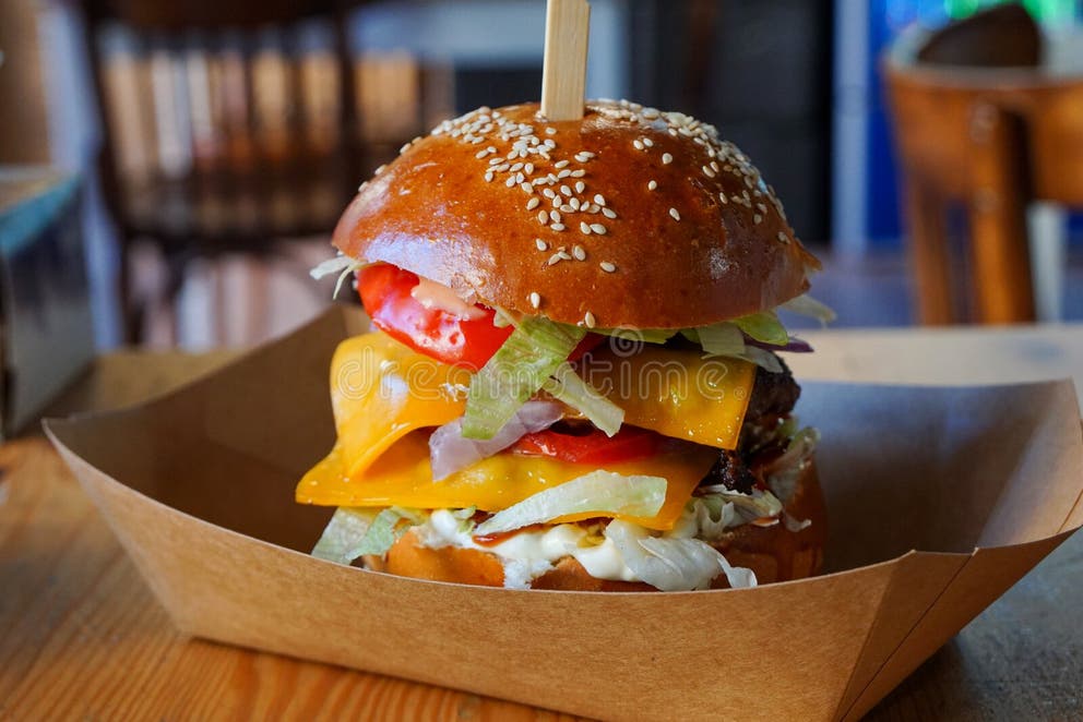 Burger on restaurant table stock photo. Image of beef - 243265716