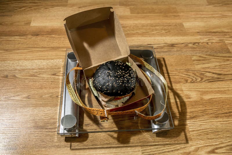 The Burger is on a Scale with a Measuring Tape Stock Image - Image of ...