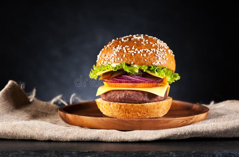 Burger on wooden plate stock photo. Image of nbeef, burger - 83606000