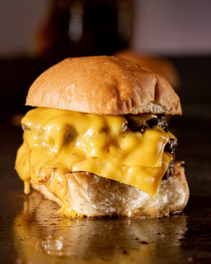 Burger with Yellow Cheese on the Griddle Stock Photo - Image of cheese ...