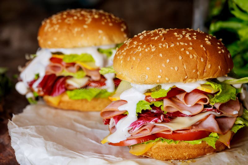 Burgers with Ham Tomato, Cheese Lettuce and Ranch. Stock Image - Image ...