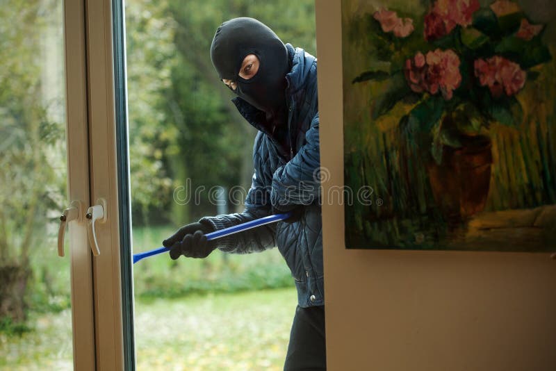 Burglar behind window stock photo. Image of property - 37686938