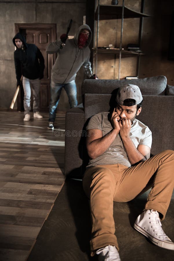 Burglars and scared man stock photo. Image of floor, hiding - 93100384