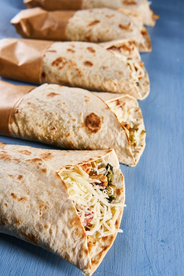Burito roll wraps on blue stock image. Image of snack - 266099399