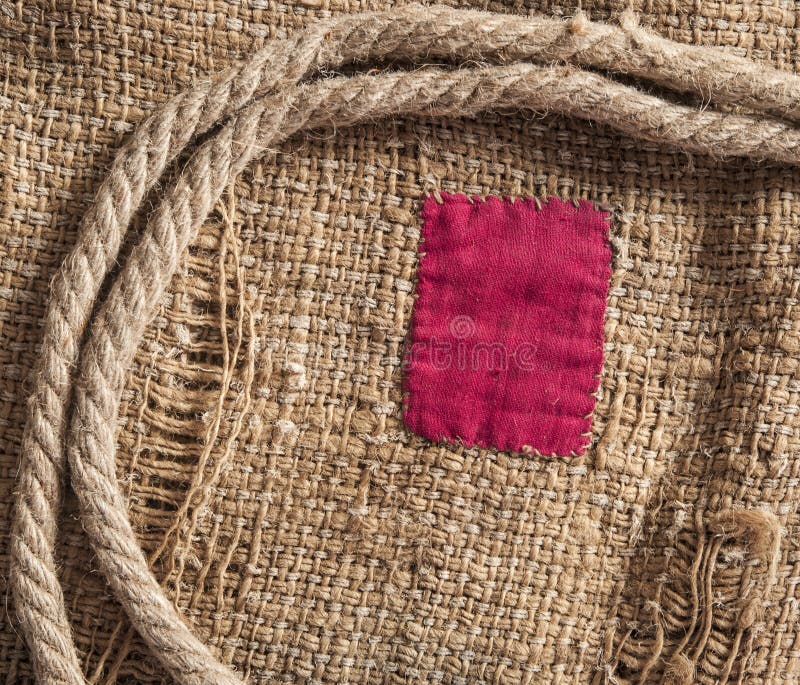 Burlap with red patch stock photo. Image of rope, closeup - 84860968