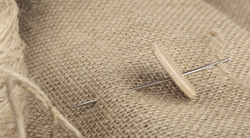 Burlap, Wooden Button and Sewing Needle Close Up Stock Image - Image of ...