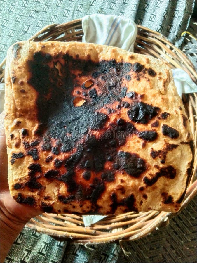Burned chapati in hand stock photo. Image of wheat, health - 252611704