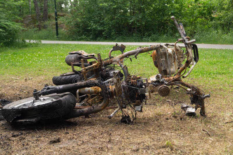 Burned Motorcycle Laying on the Ground Metal Garbage Background Stock ...
