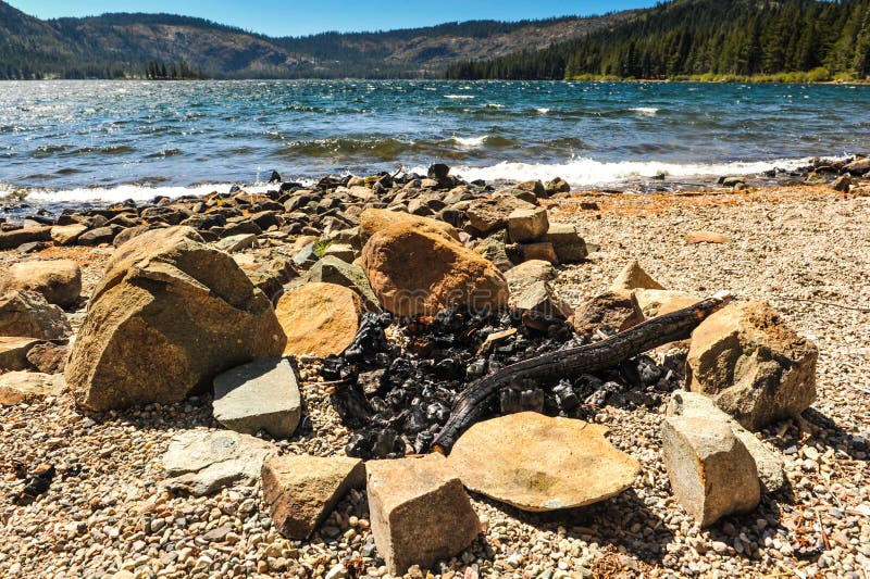 Burned Out Campfire on Beach Near Lake Stock Photo - Image of water ...