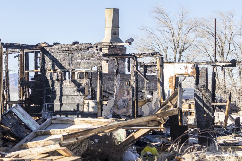 Burned Walls and a Brick Chimney are All that are Left after a House ...