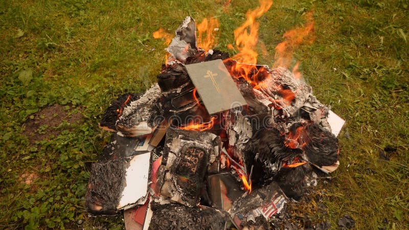 Burning Bible in a fire stock footage. Video of evil - 99912482