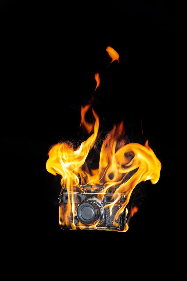 Burning Camera Close-up All on Fire on an Isolated Black Background ...