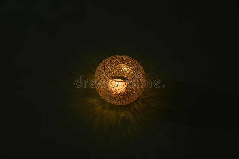 Burning Candle in a Beautiful Candlestick with a Patterned Shadow on a ...