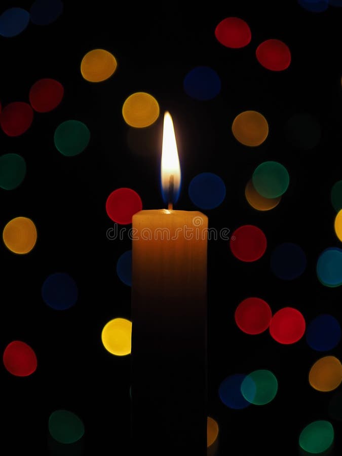 Burning Candle Close-up and Multi-colored Bokeh on a Black Background ...