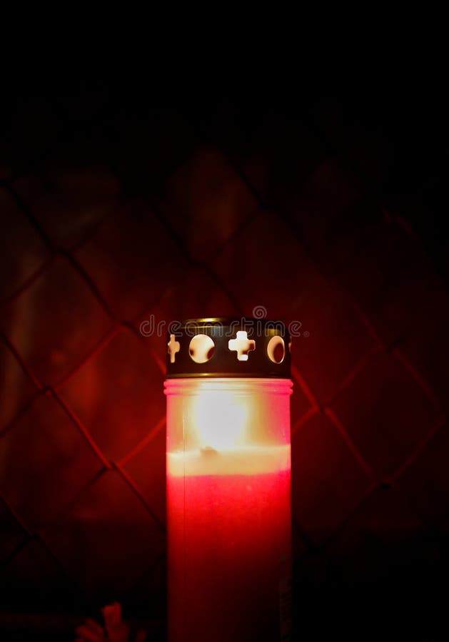 Burning Candle in Front of a Metallic Net during the Night Stock Photo ...