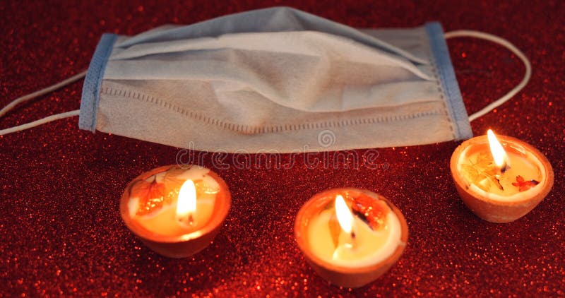 Candles and a Protective Face Mask on the Red Surface; Diwali Festival ...