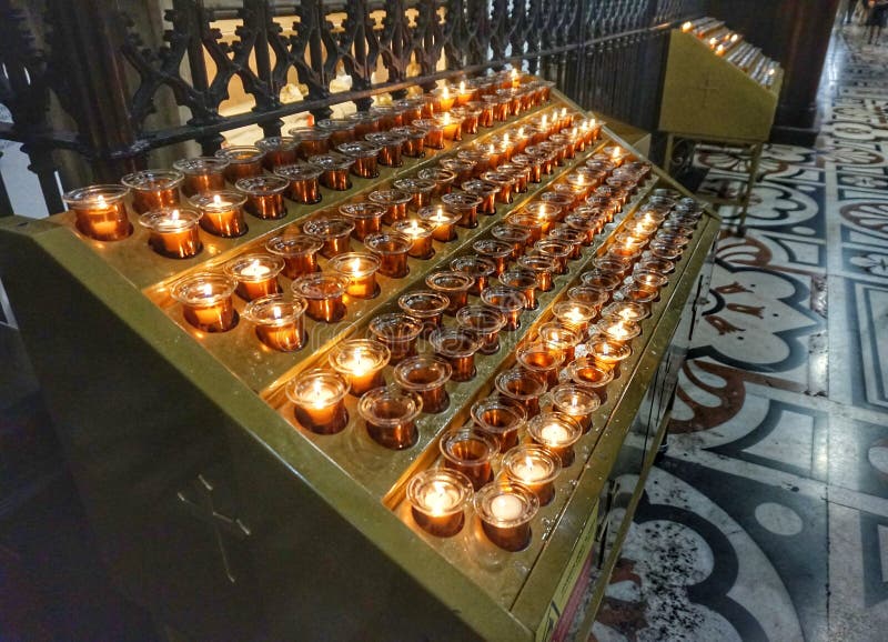 Burning Candles on a Stand in One of the Catholic Churches Editorial ...