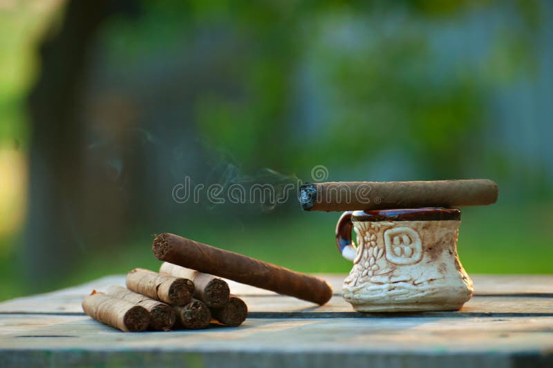 Burning cigar and coffee stock image. Image of table - 79980395