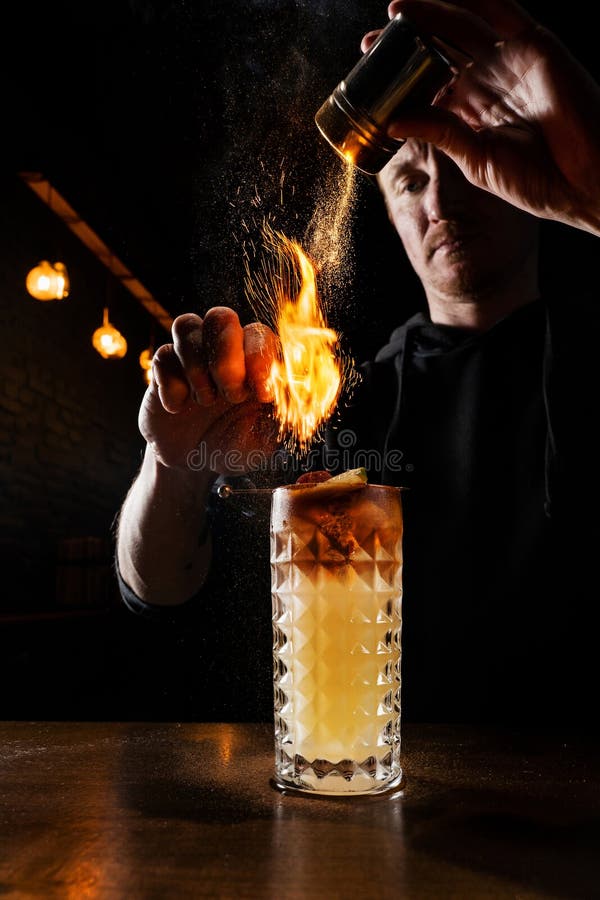 Burning Cinnamon in Cocktail. Bartender Pours and Fire Burns Cinnamon ...
