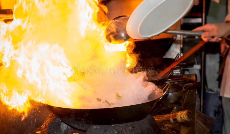 Professional Chef in a Commercial Kitchen Cooking Flambe Style Stock ...