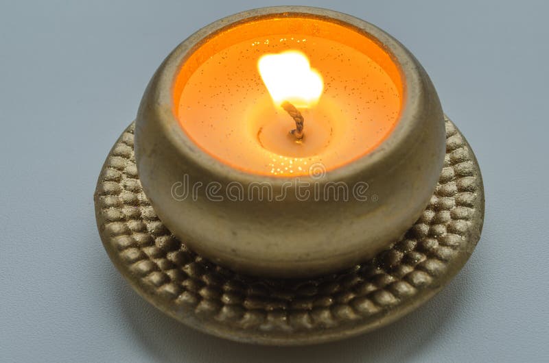 Burning Decorative Candle in Gold Color Stock Photo - Image of gold ...