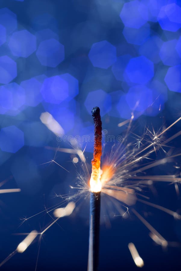 Burning Flickering Sparkler on the Background of Blue Lights Bokeh ...