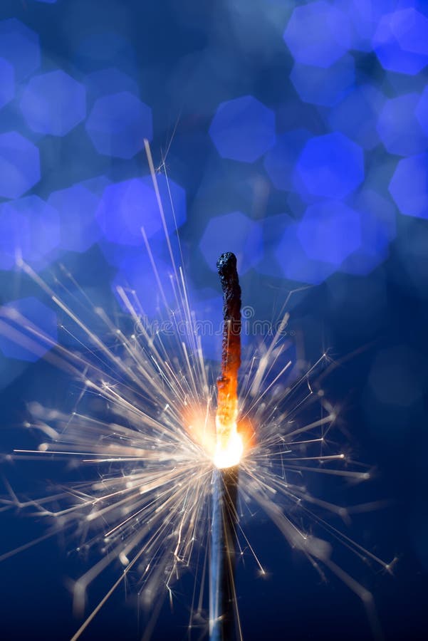Burning Flickering Sparkler on the Background of Blue Lights Bokeh ...