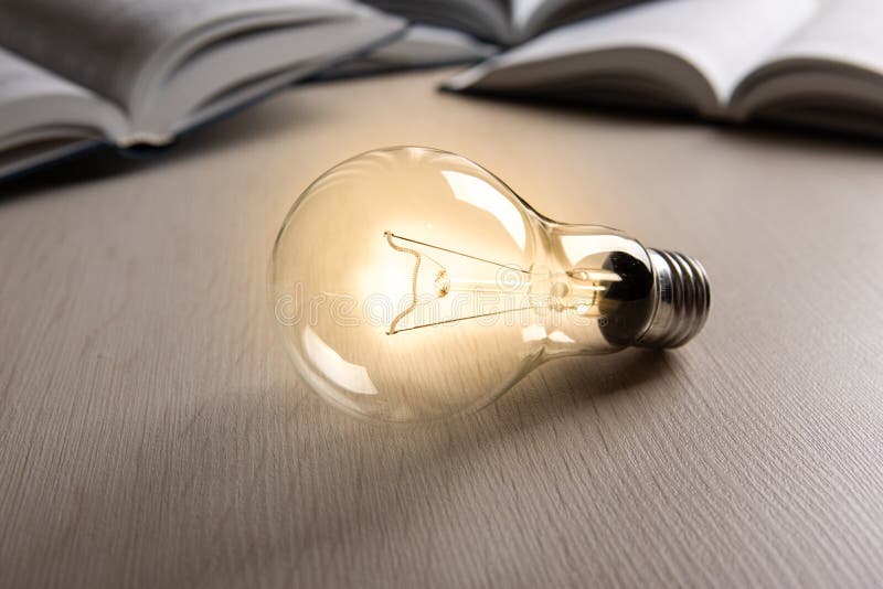 Burning Glass Bulb on the Background of Books Search for Ideas Stock ...