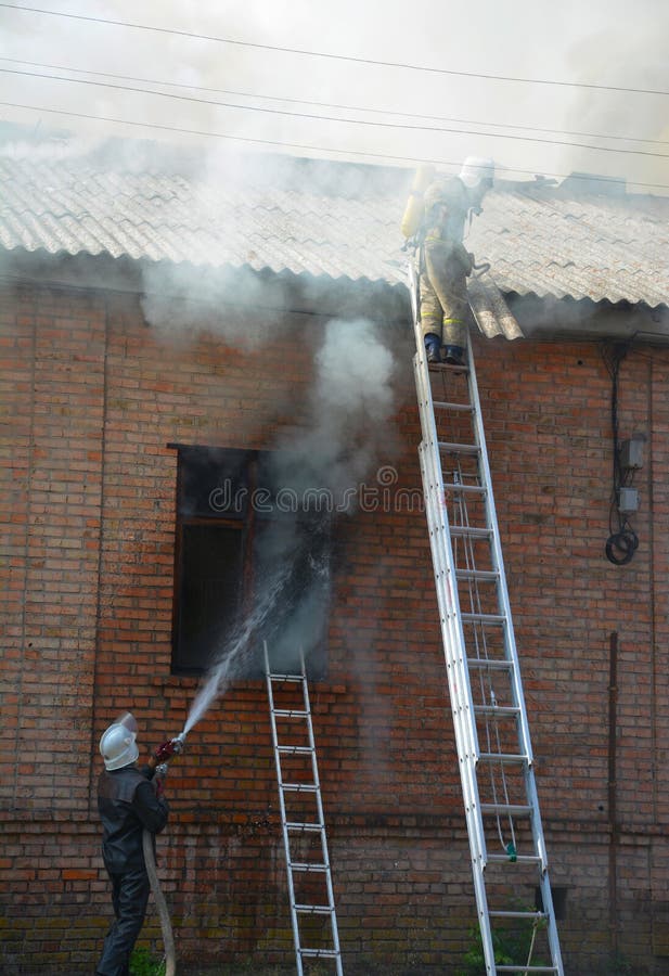 Burning House and Firefighters on the Ladders Editorial Stock Image ...
