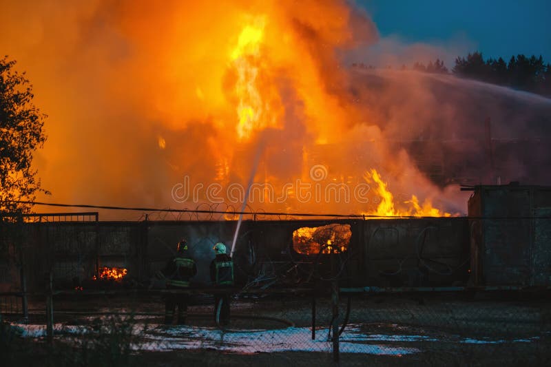 Burning Industrial Building. Firefighters Extinguish Burning Industrial ...