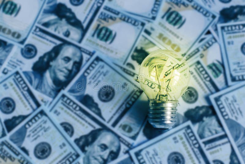 Burning Light Bulb on Dollars Background, Expensive Electricity Stock ...