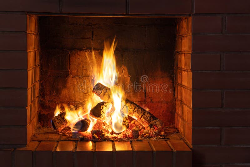 Burning Logs and Embers in a Red Brick Fireplace in a Country Cottage ...