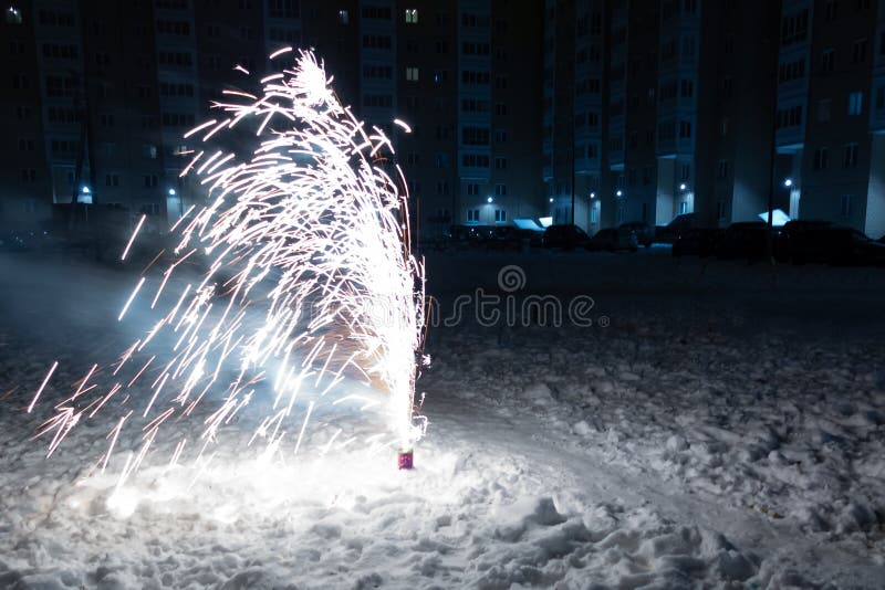Burning Mini Fireworks in the Snow on a Winter Evening Stock Photo ...