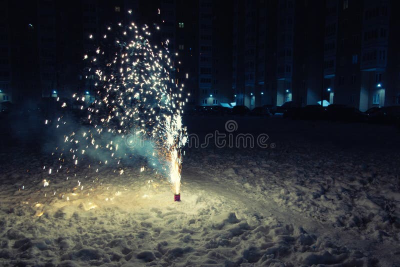 Burning Mini Fireworks in the Snow on a Winter Evening Stock Image ...