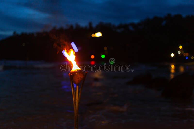 Burning Torch on the Sandy Beach of the Ocean Stock Photo - Image of ...