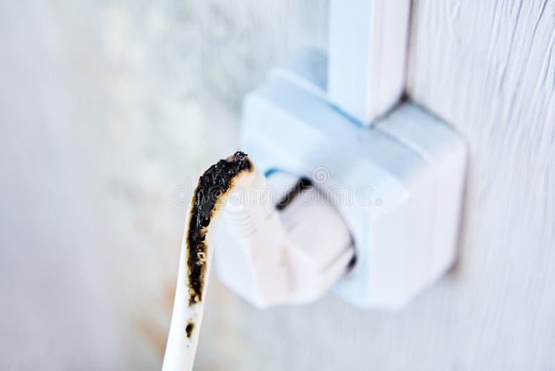 Burnt Electrical Cord Plugged into Wall Socket. Stock Image - Image of ...